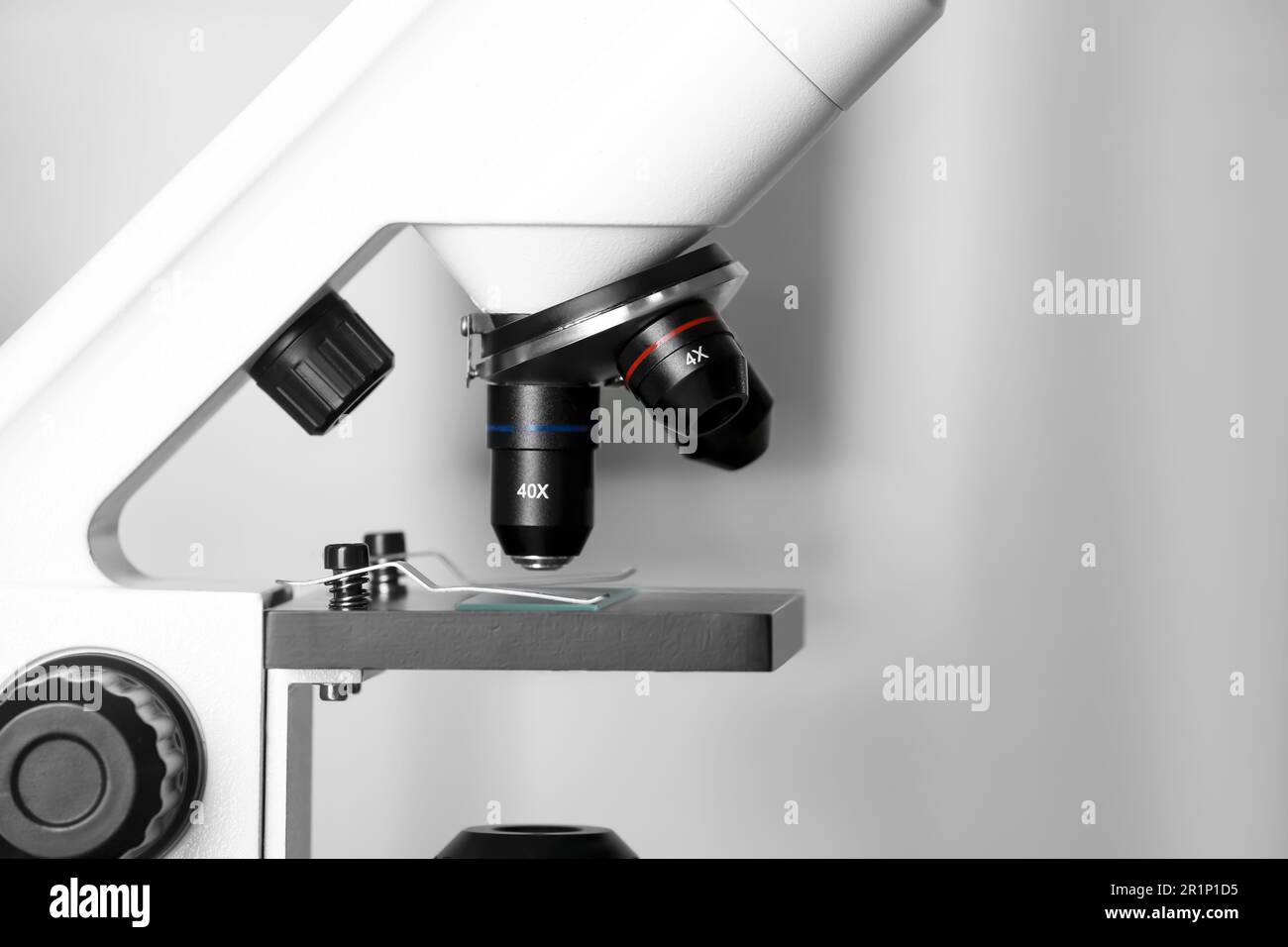 Modern medical microscope with glass slide on blurred background ...