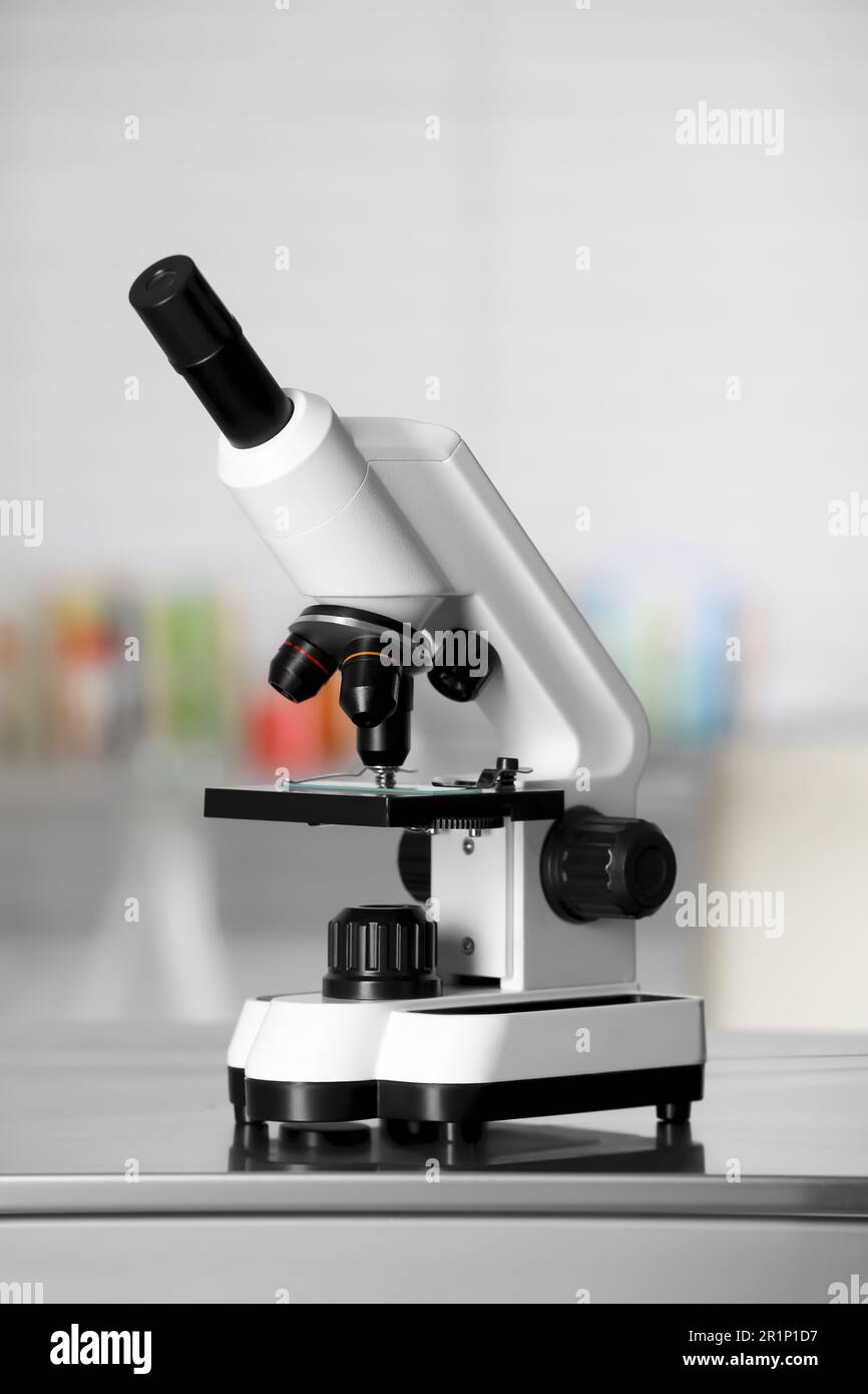 Modern medical microscope on metal table in laboratory Stock Photo - Alamy