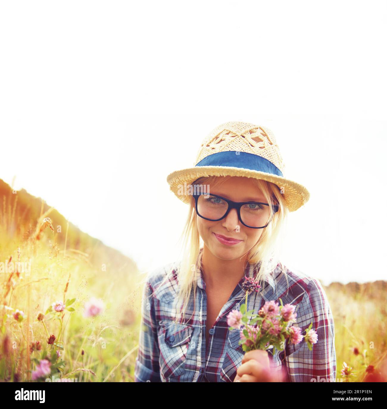Portrait, countryside and woman with flowers in field for freedom ...