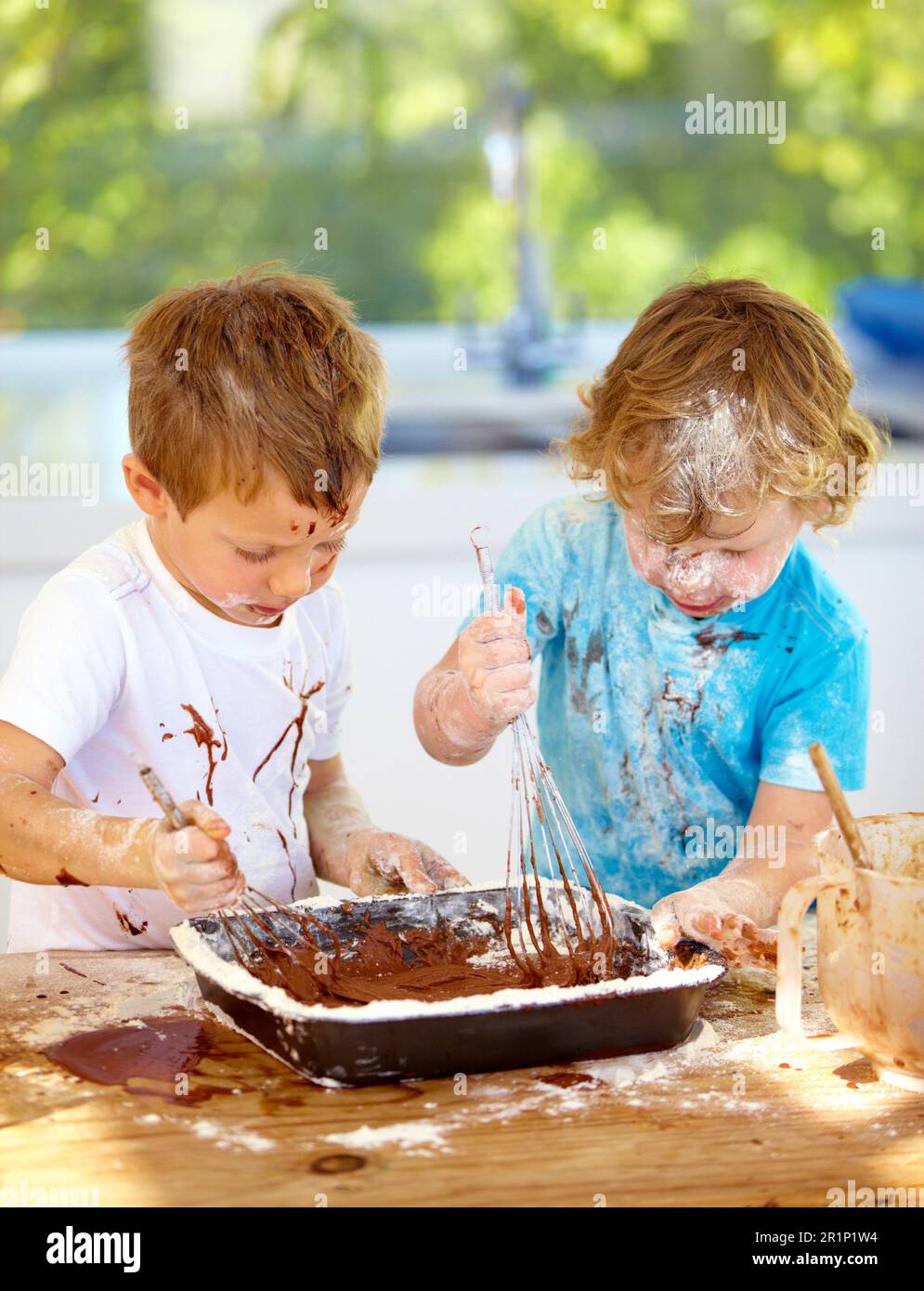 Baking, kids and messy friends in the kitchen together, having fun with ...