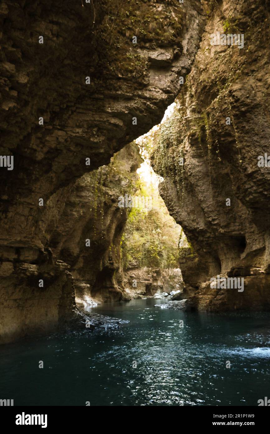 Picturesque view of clean river near cliffs and waterfall outdoors ...