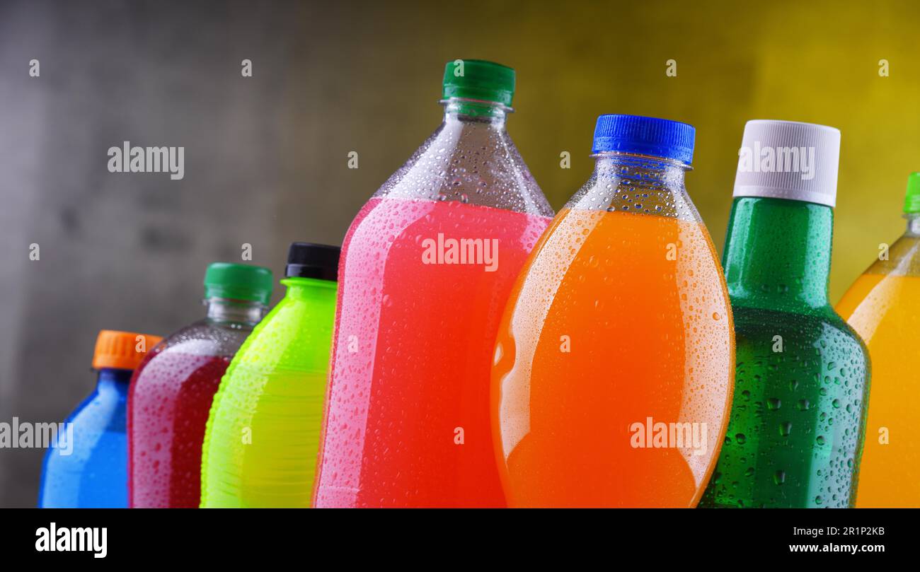 Plastic bottles of assorted carbonated soft drinks in variety of colors ...