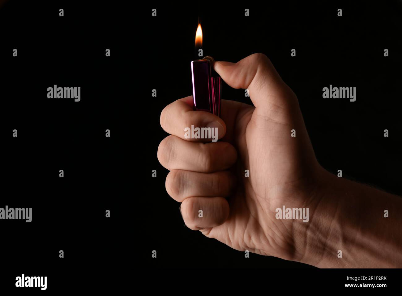 Man holding lighter on black background, closeup. Space for text Stock ...