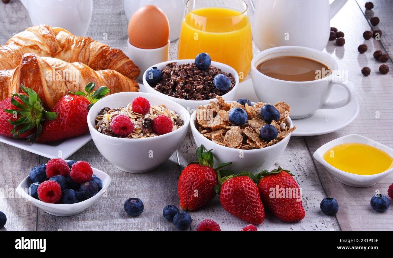 Breakfast served with coffee, orange juice, croissants, egg, cereals ...