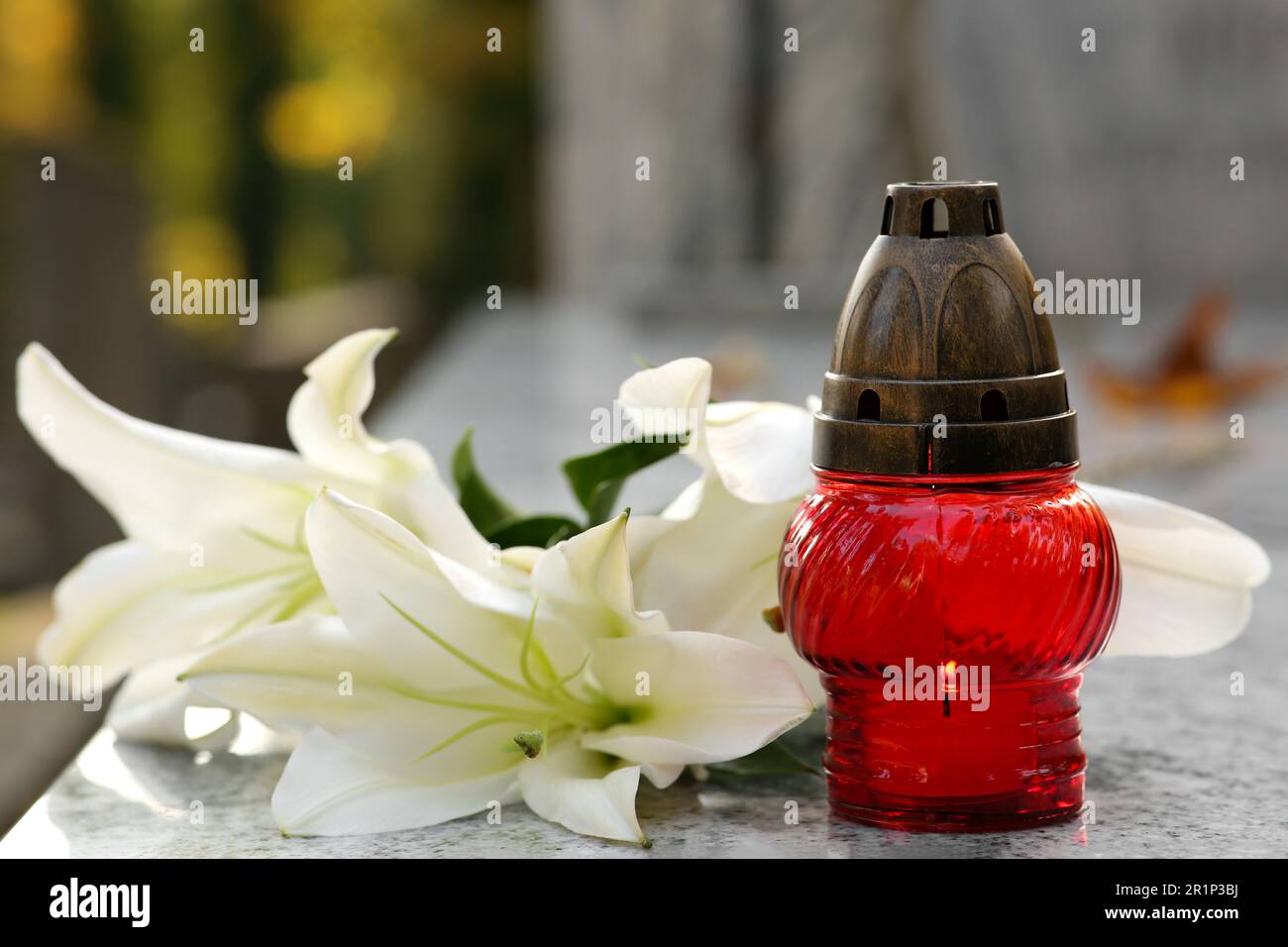 White lilies and grave lantern on granite tombstone outdoors. Funeral ceremony Stock Photo - Alamy
