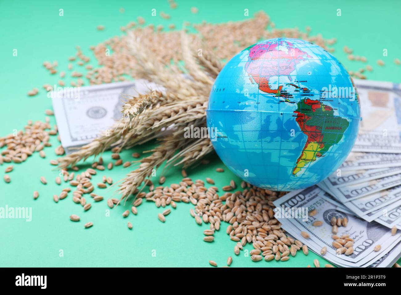 Import and export concept. Globe, wheat grains, and banknotes on green ...