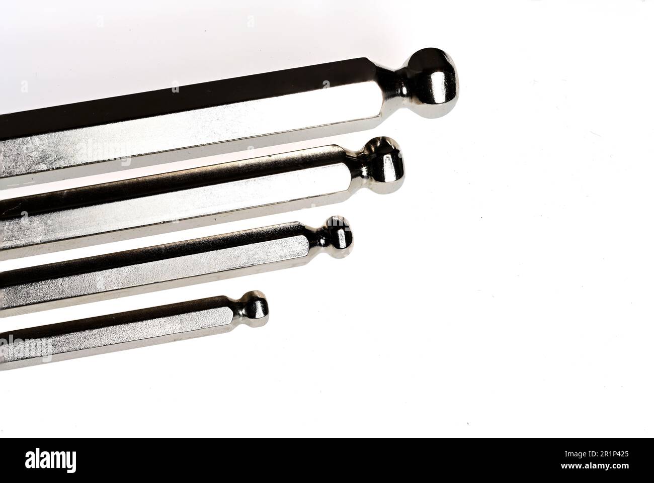 Extreme closeup partial view of four different sized thick silver shiny ...