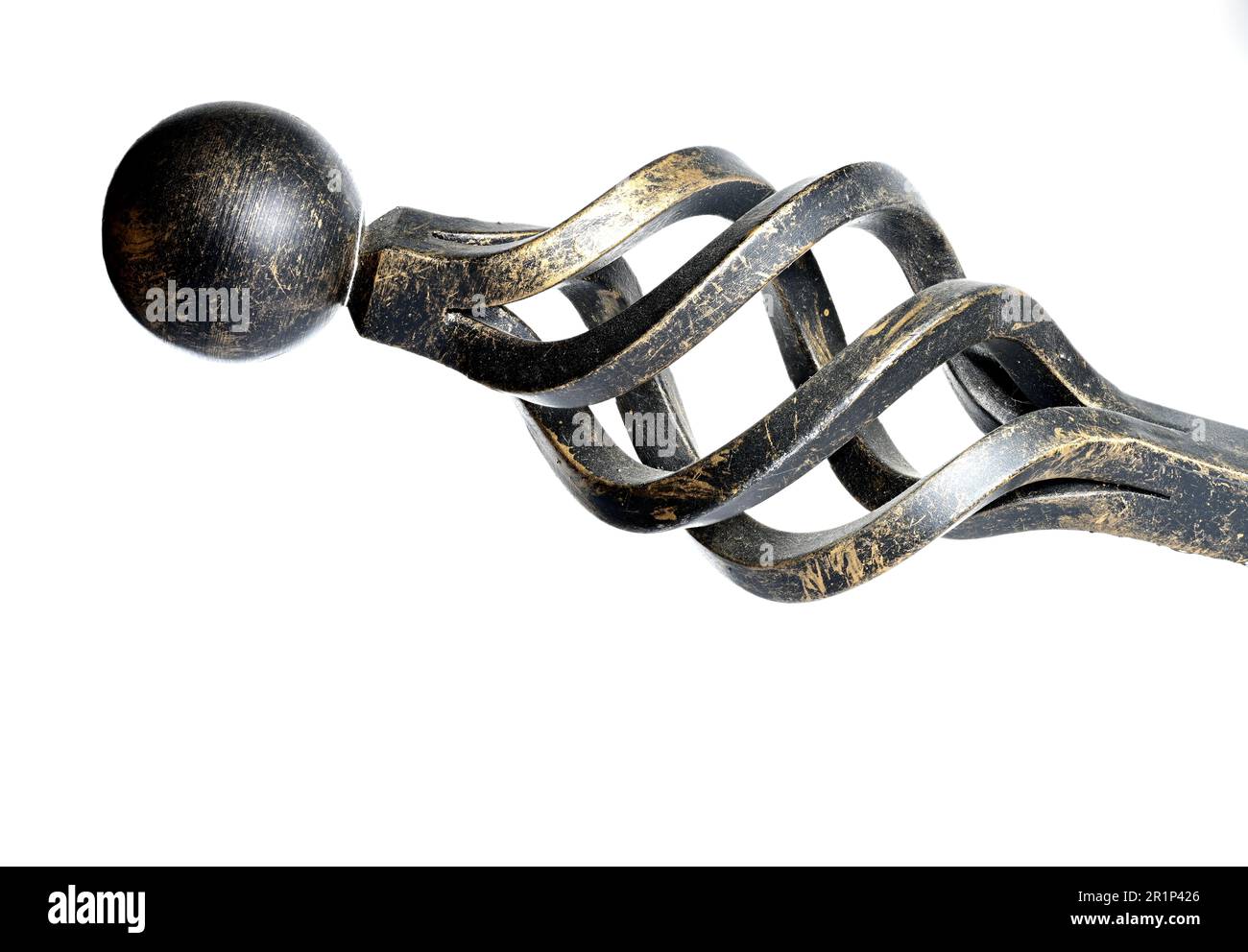 Close up of ornate curved forged finial of wrought iron curtain rod ...