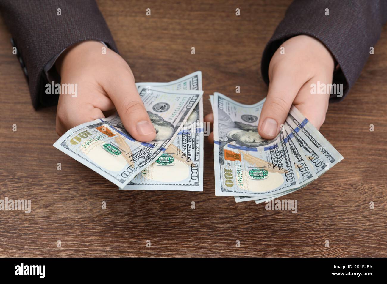 Male hands counting us dollar hi-res stock photography and images - Alamy