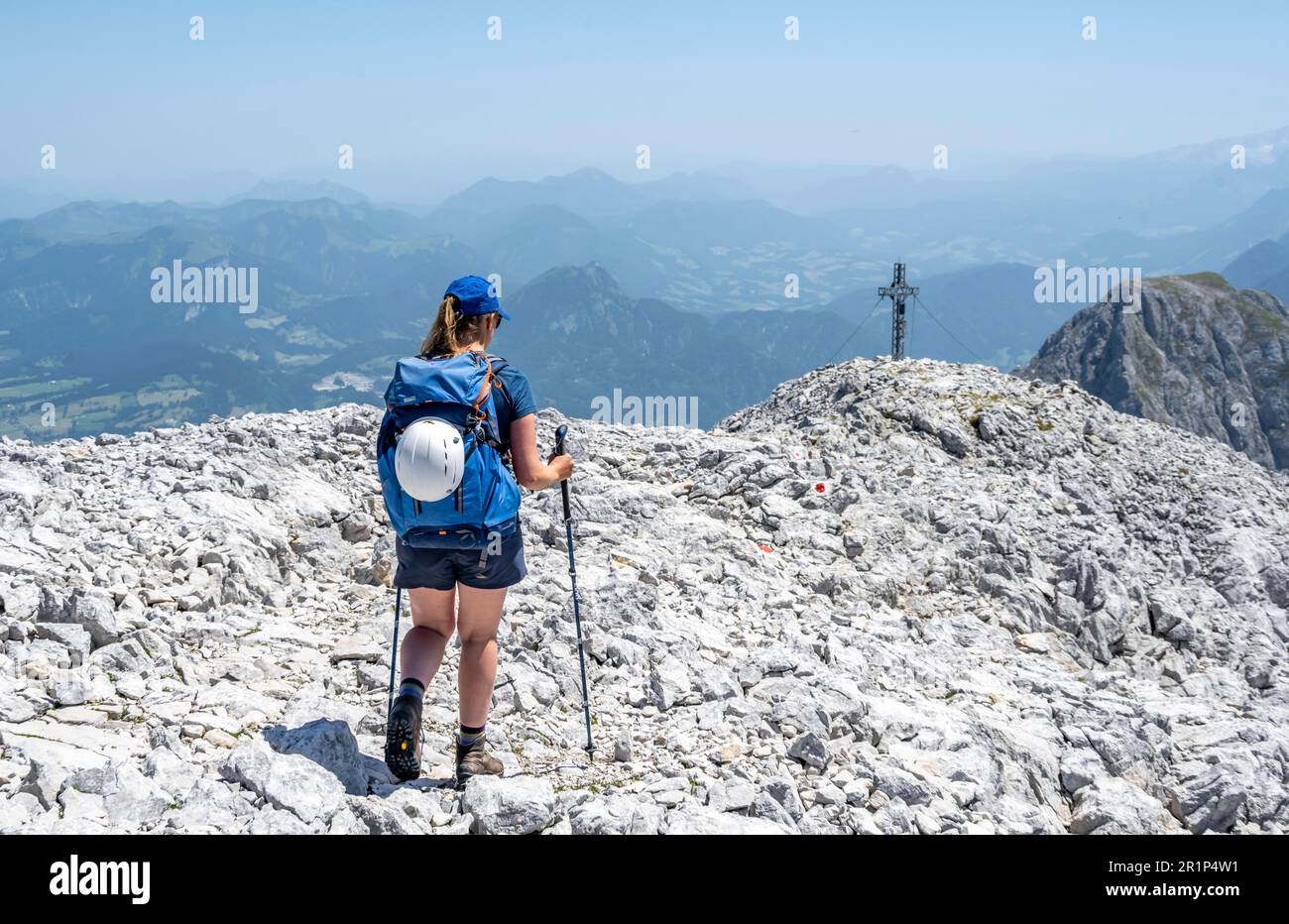 Mountaineer at the summit, hiking over scree field, mountain landscape ...