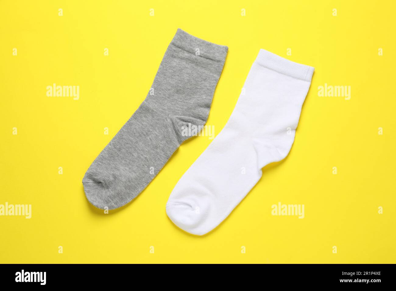 White and grey socks on yellow background, flat lay Stock Photo - Alamy