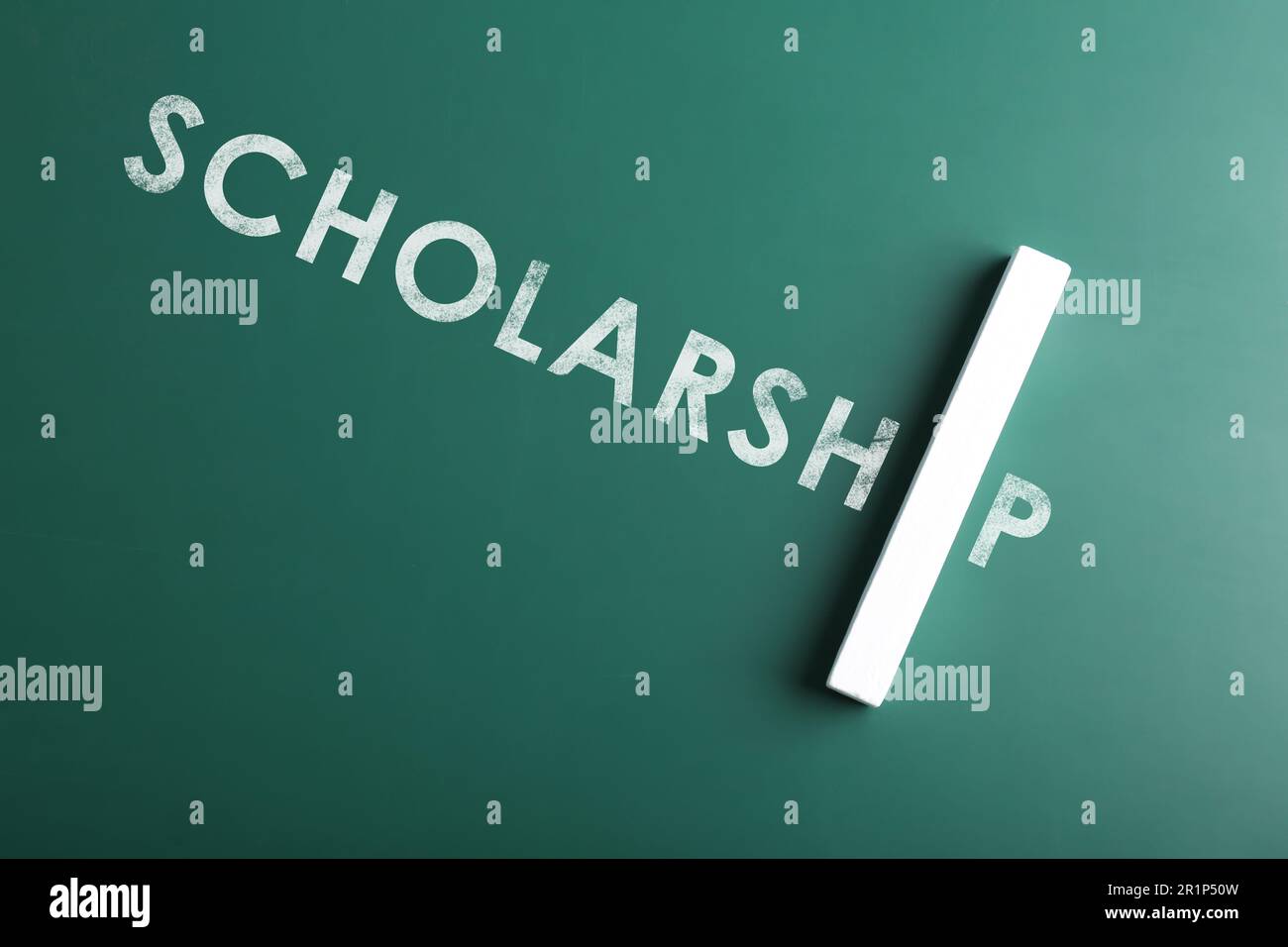 Word Scholarship And Piece Of Chalk On Green Chalkboard Top View Stock