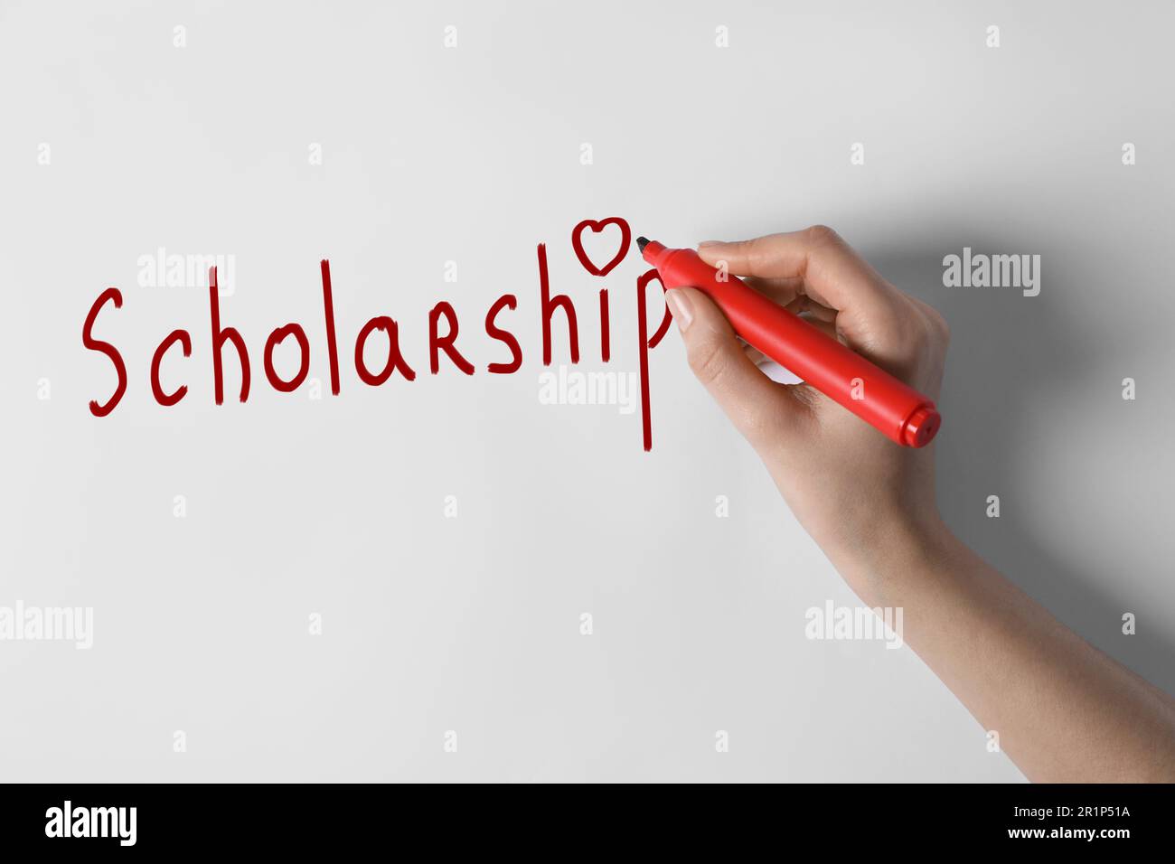 Woman writing word SCHOLARSHIP on white paper, closeup Stock Photo - Alamy