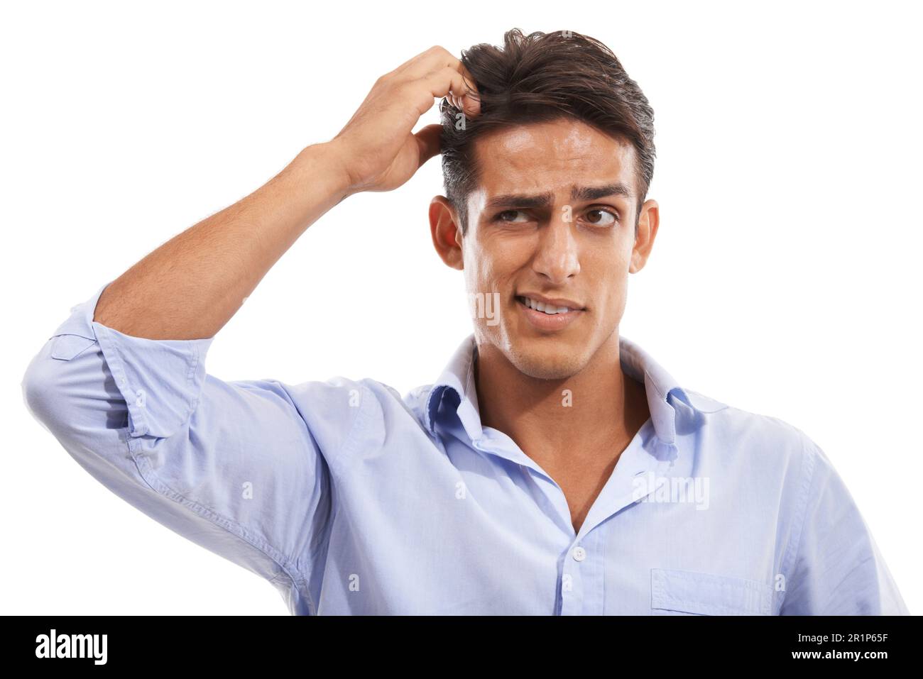 Im stumped. A handsome young man scratching his head in confusion ...