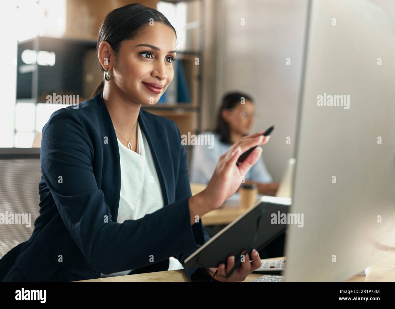 Making notes for future reference. a businesswoman comparing her notes ...