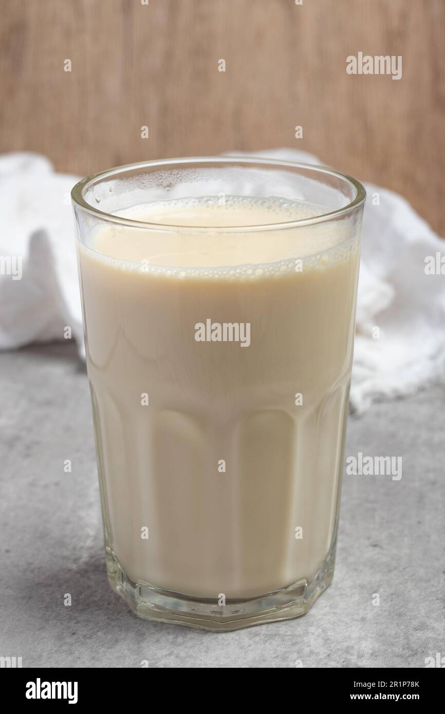 Hot fresh milk in transparent glass on gray background Stock Photo - Alamy