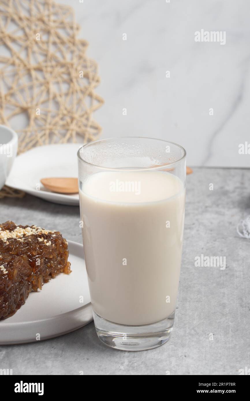 Hot fresh milk in transparent glass on gray background Stock Photo - Alamy