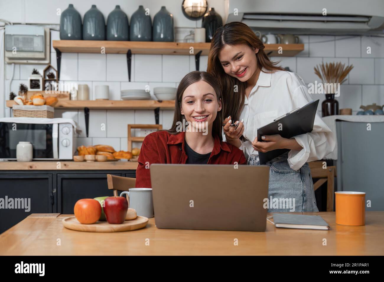 Two girls watching laptop. Watch Video Play social media, vacation ...