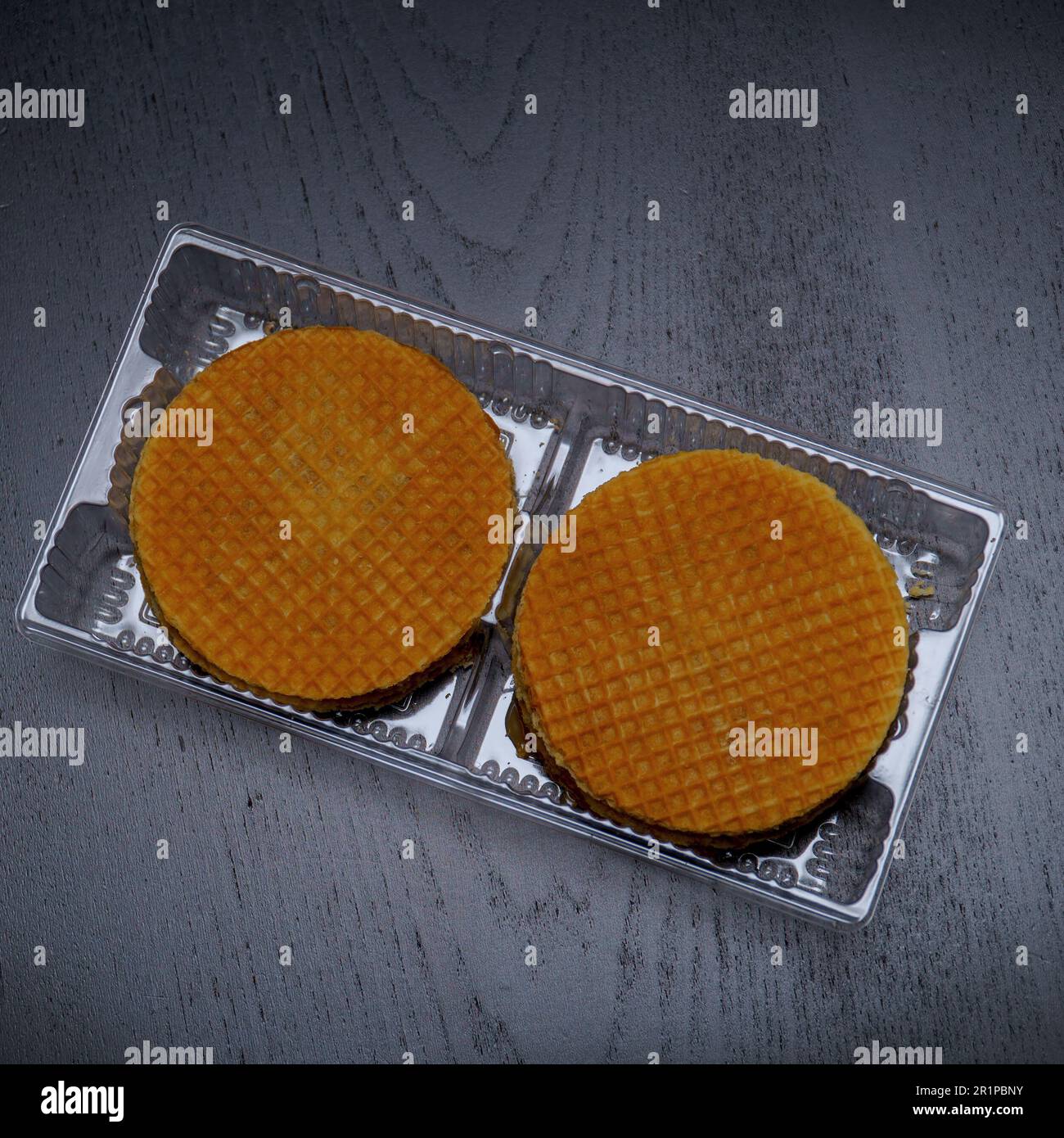 Delicious cookies in plastic packaging on a dark background Stock Photo ...