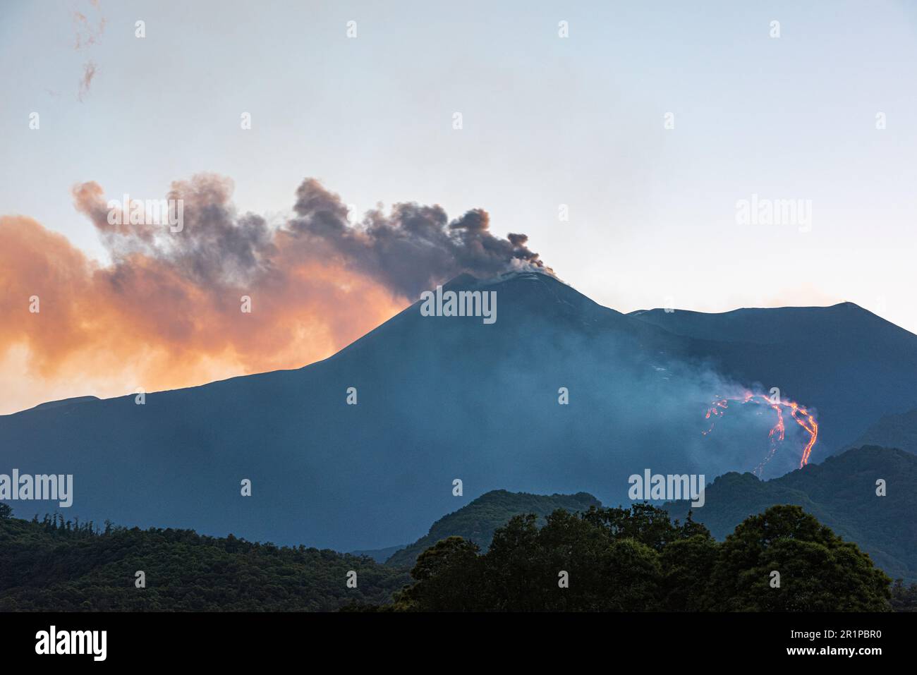 Europe's most active volcano Mount Etna, Sicily, seen at sunset, with a ...