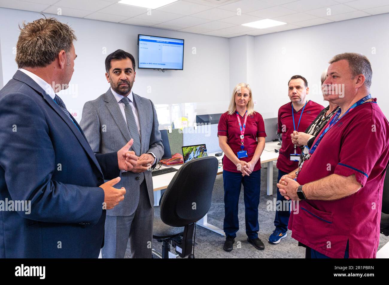Scottish First Minister Humza Yousaf with Jim Miller (centre) speaking ...