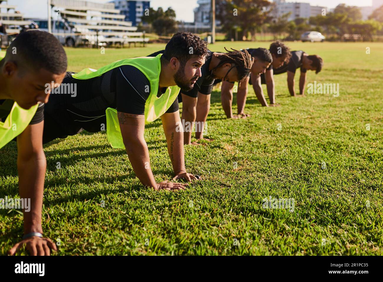 Building core strength. a diverse group of sportsmen training during a ...
