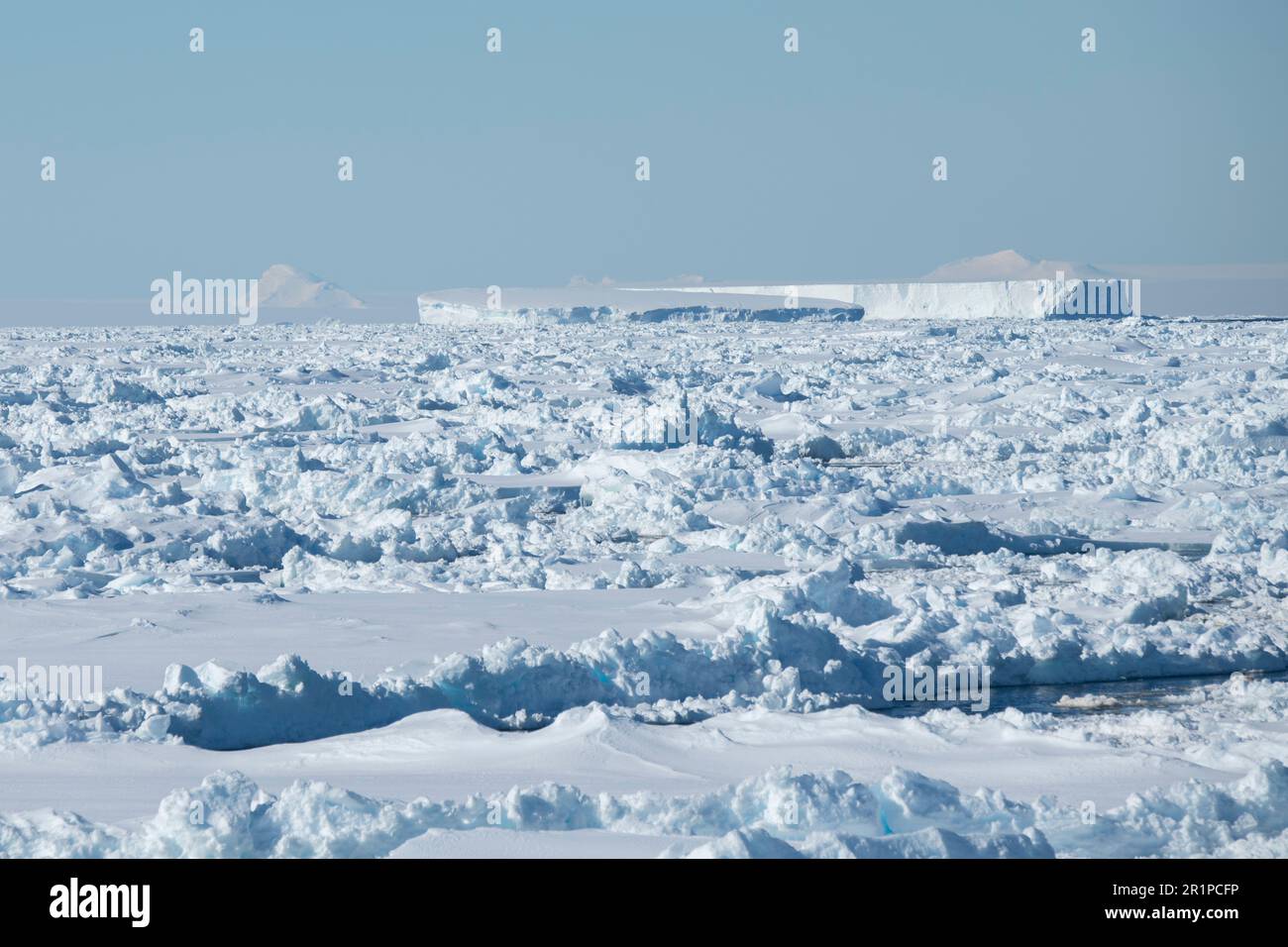 Antarctica, pack ice on the Amundsen Sea with iceberg an mountains in ...