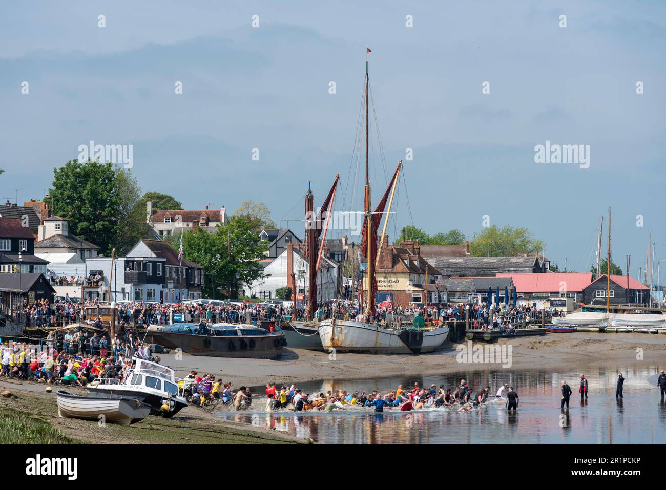 Runners taking part in the Maldon Mud Race in Maldon, Essex, UK, in the ...