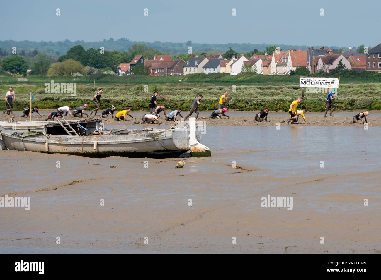 Runners taking part in the Maldon Mud Race in Maldon, Essex, UK, in the ...