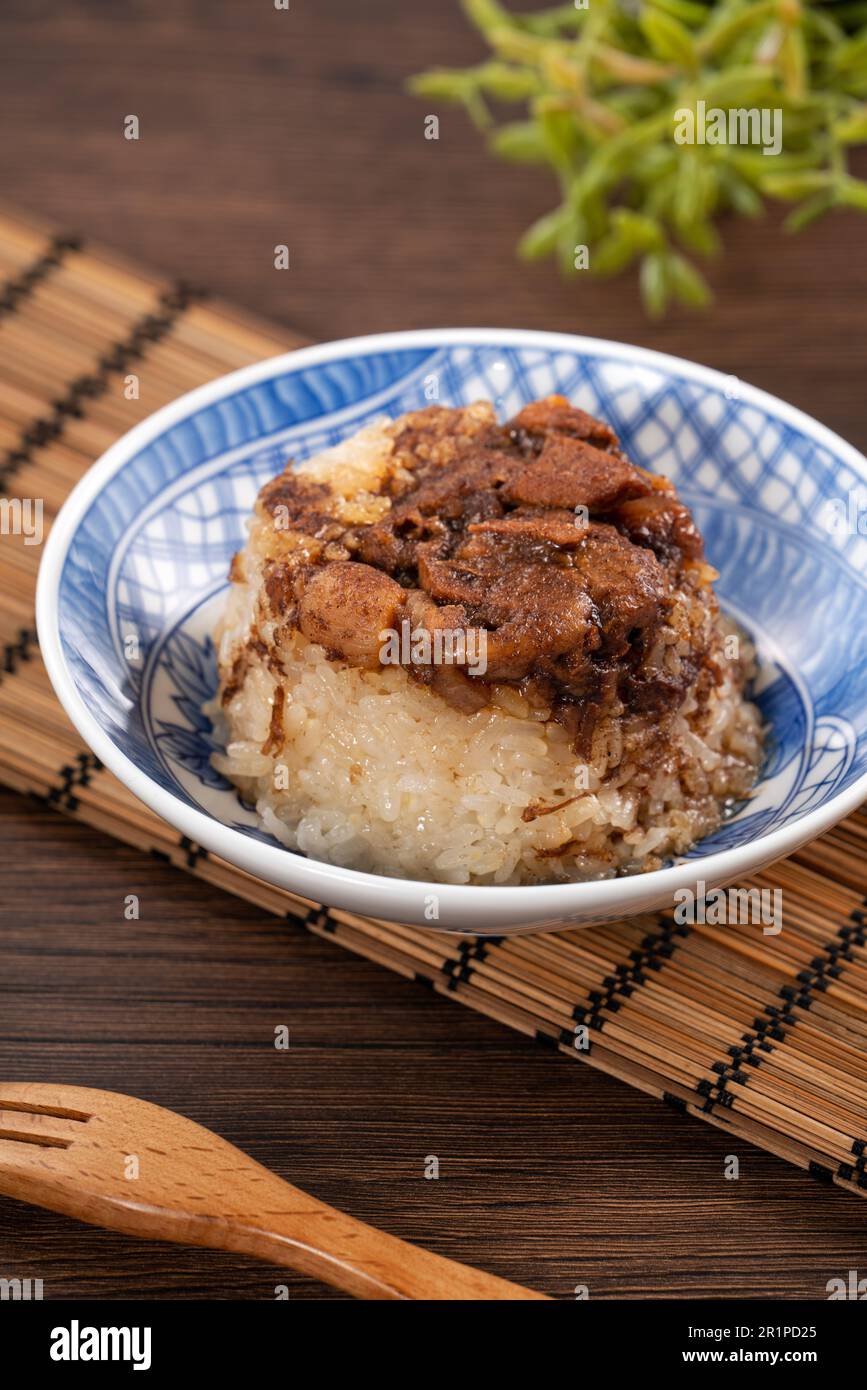 Migao, tube rice cake, rice pudding in a bowl topped with minced pork ...