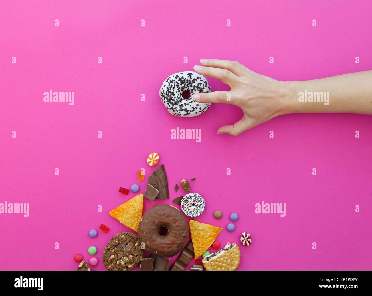 Hand grabs candy Stock Photo - Alamy