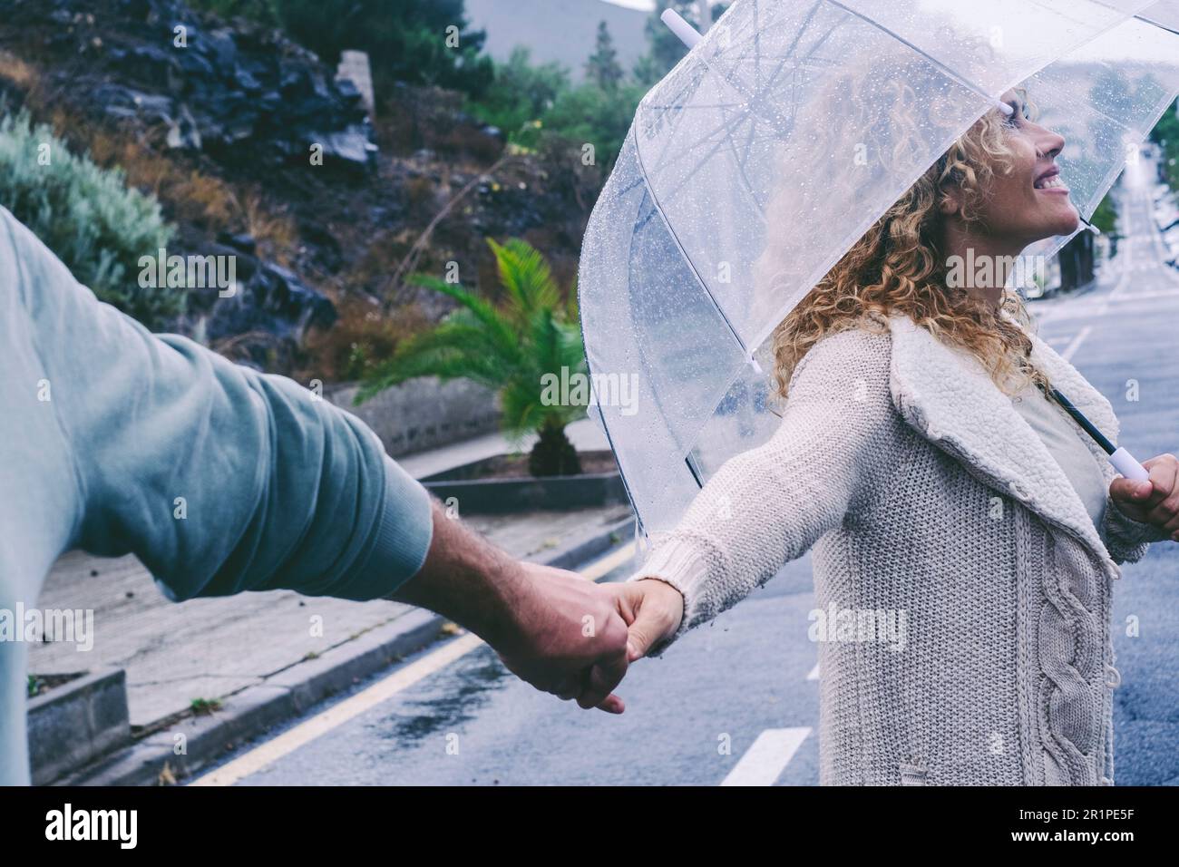 Couple Holding Hands In Rain