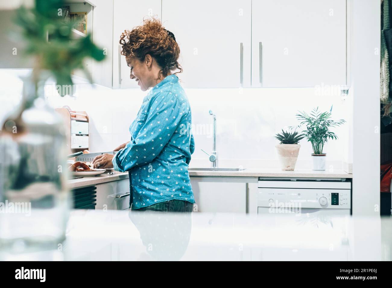 Kitchen, woman, cooking, standing, sideways Stock Photo - Alamy