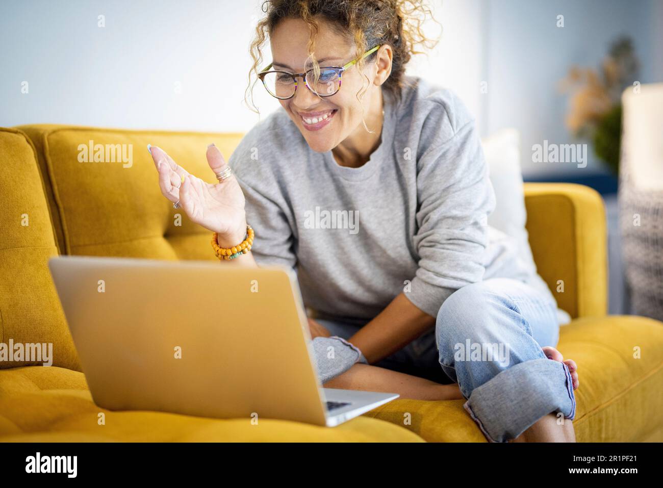 Modern happy young woman smile and have fun in video call computer ...