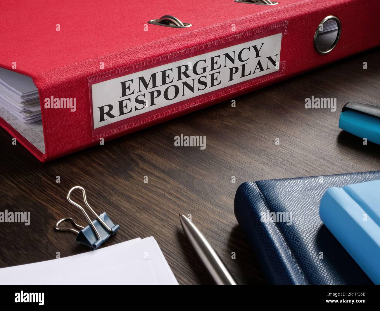 Red folder with Emergency response plan on the desk Stock Photo - Alamy