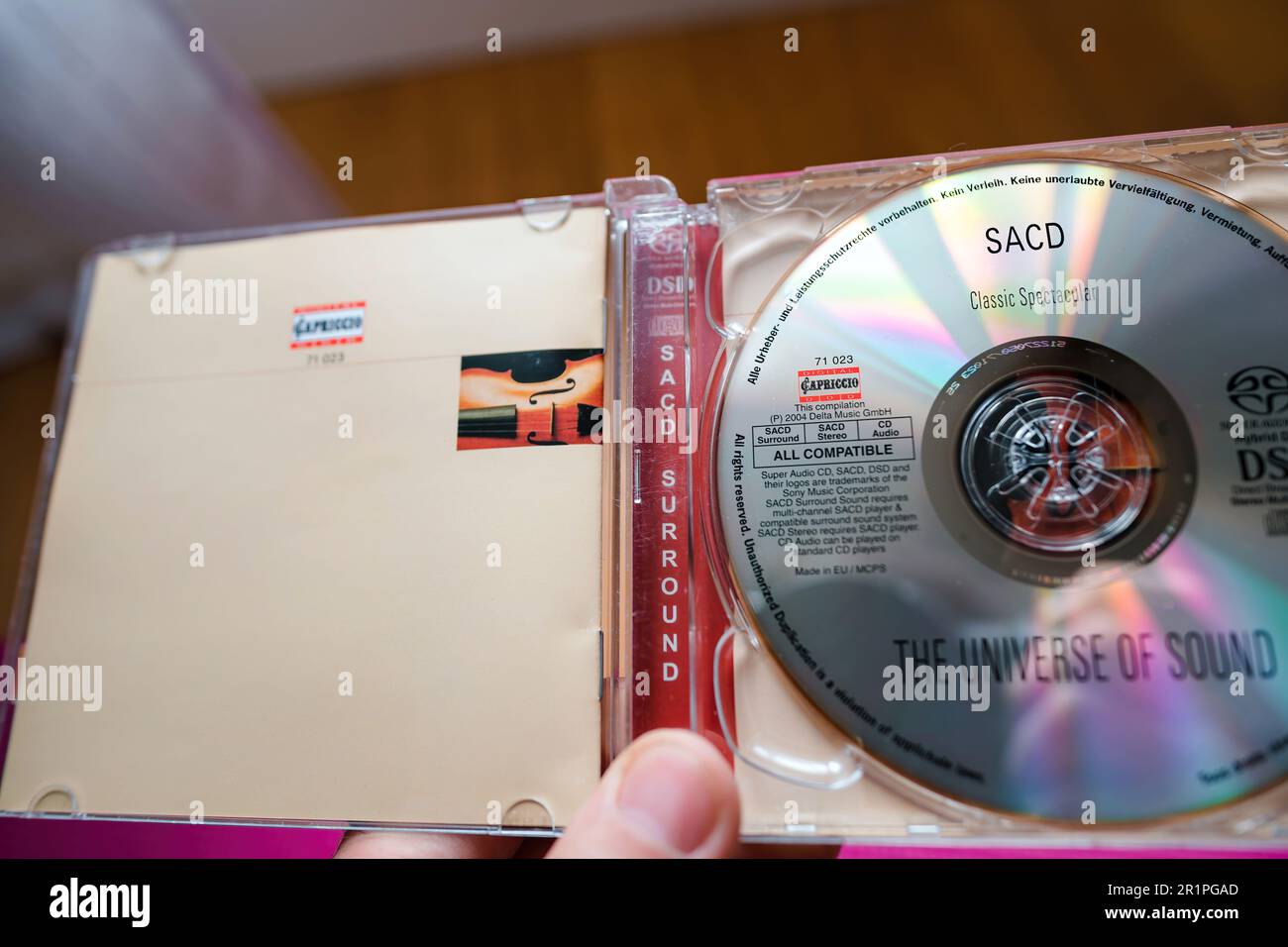 Paris, France - May 11, 2023: An up-close view of a Super Audio CD disk, playing the timeless ...