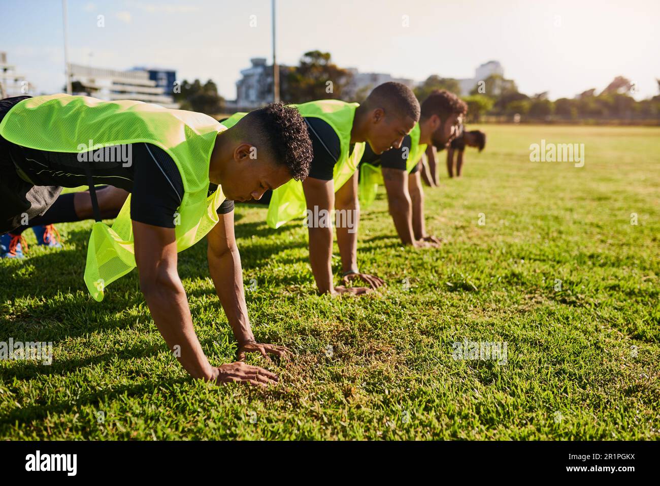 Working on our arm strength. a diverse group of sportsmen training ...