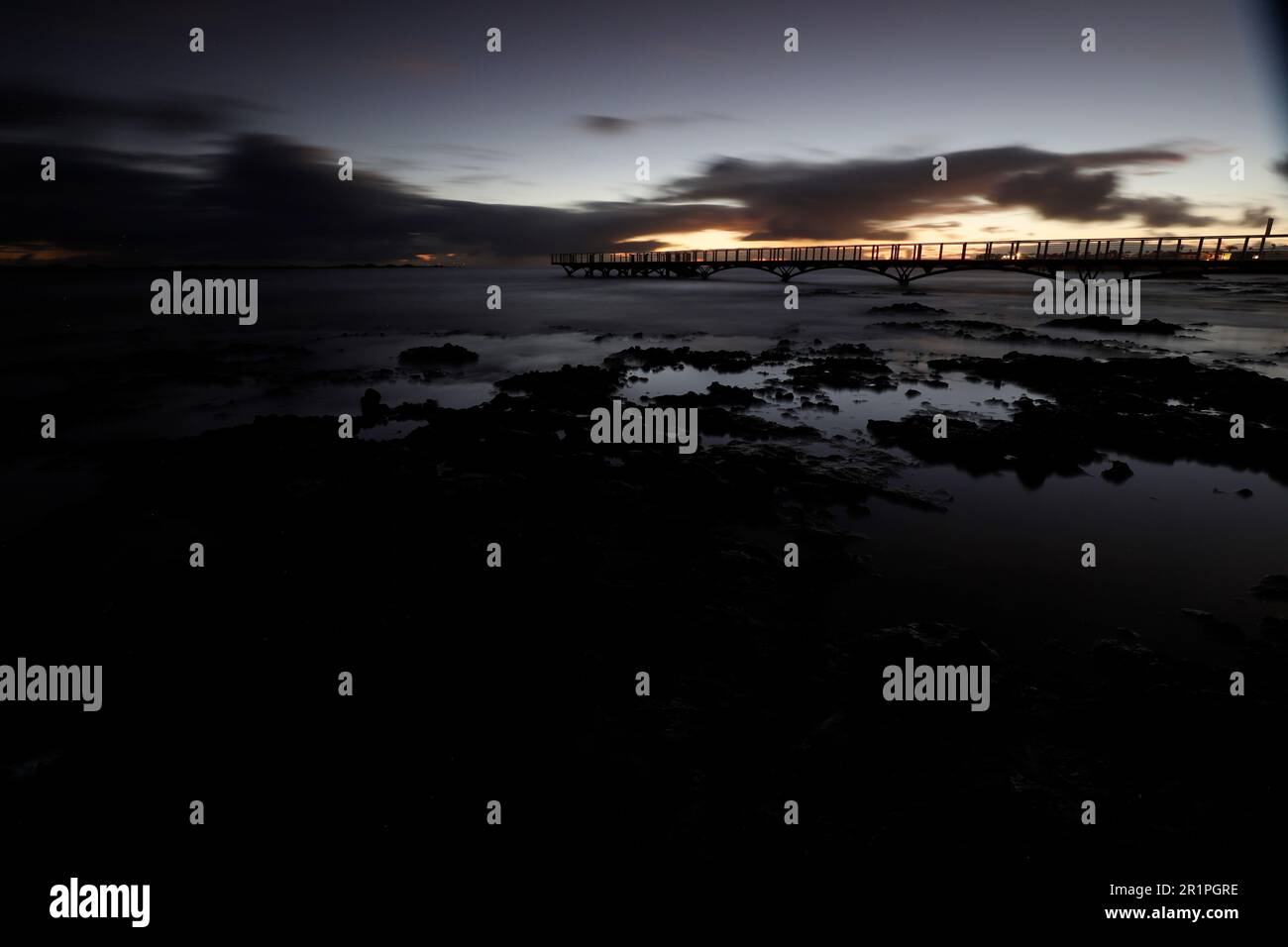 Long exposure on stony beach with jetty pier on fuerteventura hi-res ...