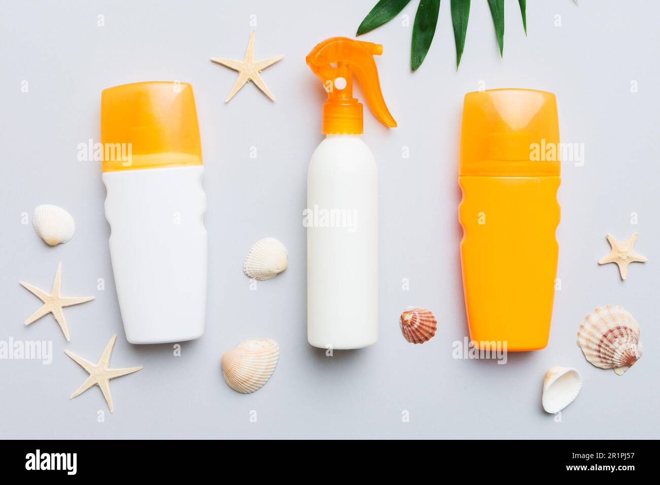 Sunscreen spray bottle. Bottle with sun protection cream and sea shells ...