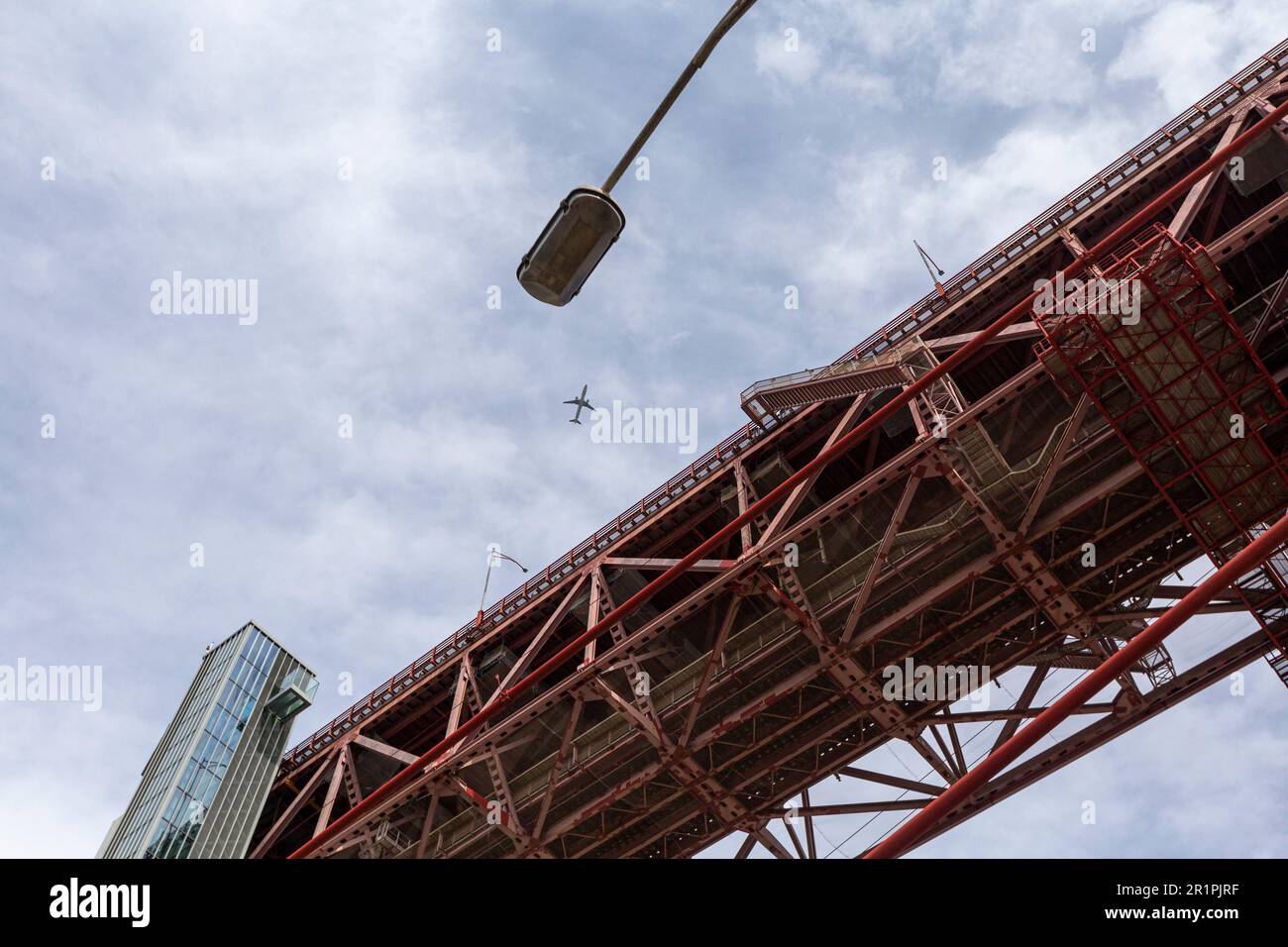 A Plane and The 25 April bridge (Ponte 25 de Abril) is a steel ...
