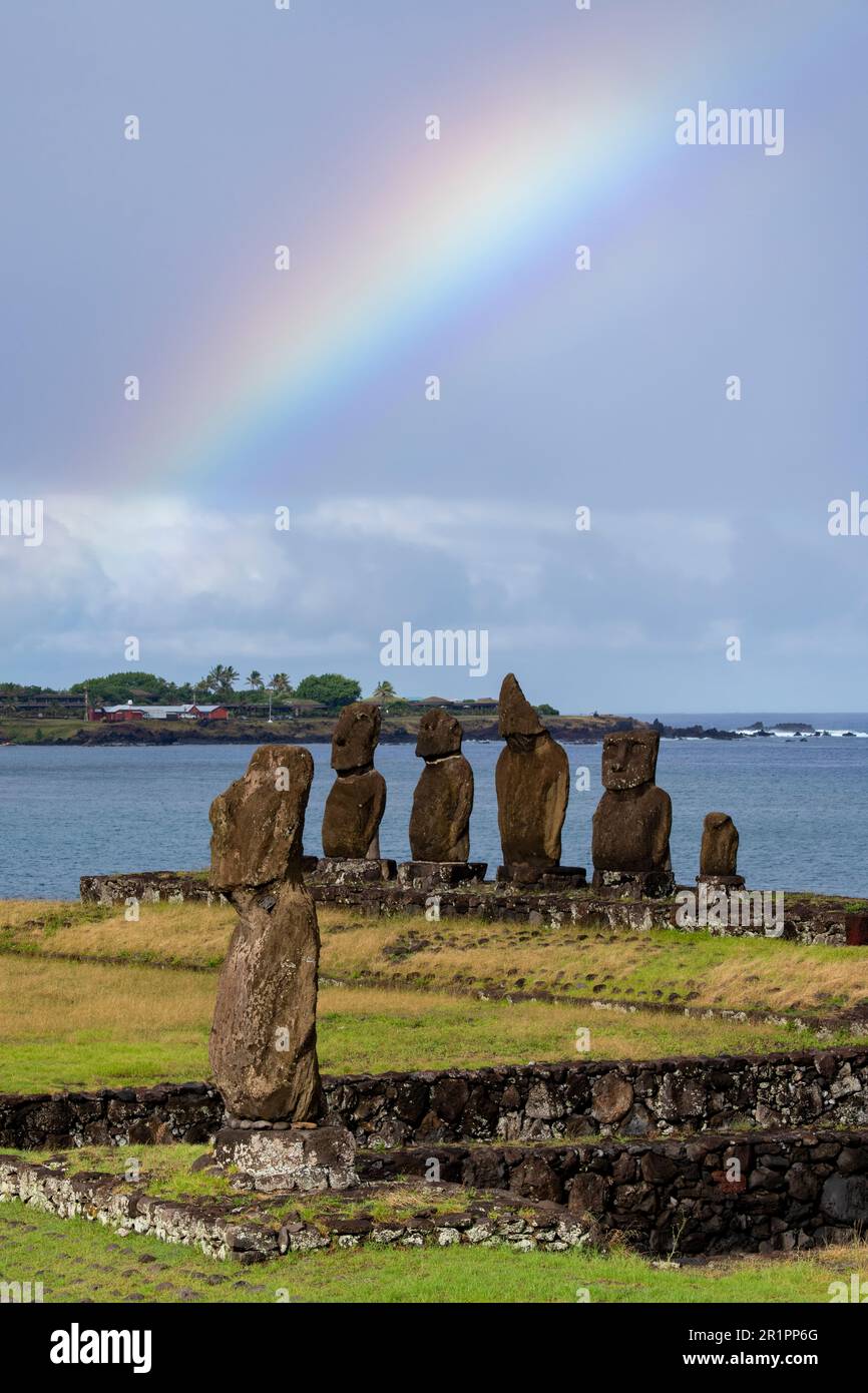 Chile, Easter Island aka Rapa Nui, Ahu Tahai. Moai with rainbow, town ...