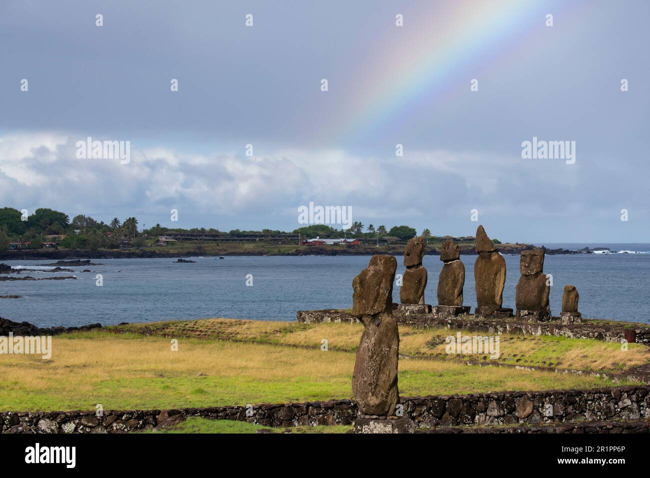 Chile, Easter Island aka Rapa Nui, Ahu Tahai. Moai with rainbow, town ...