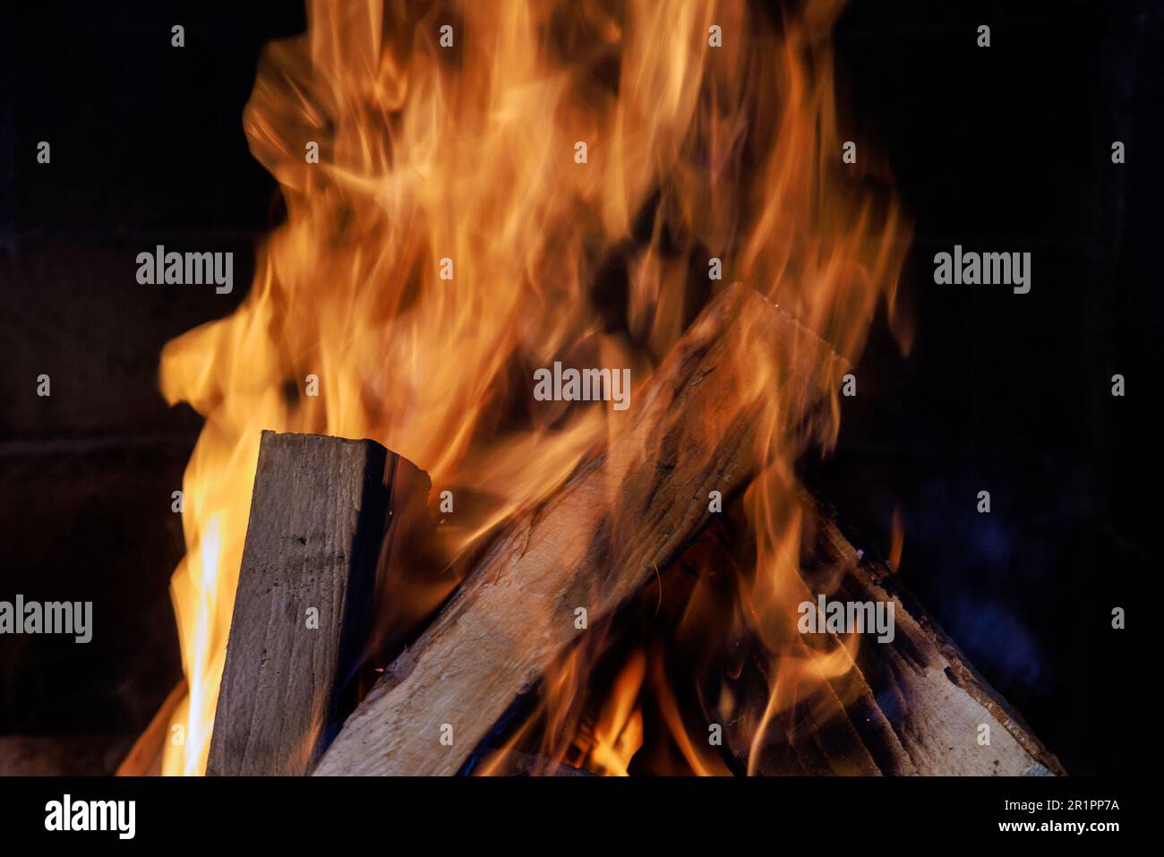 Firewood burning in traditional rural fireplace an winter time Stock ...