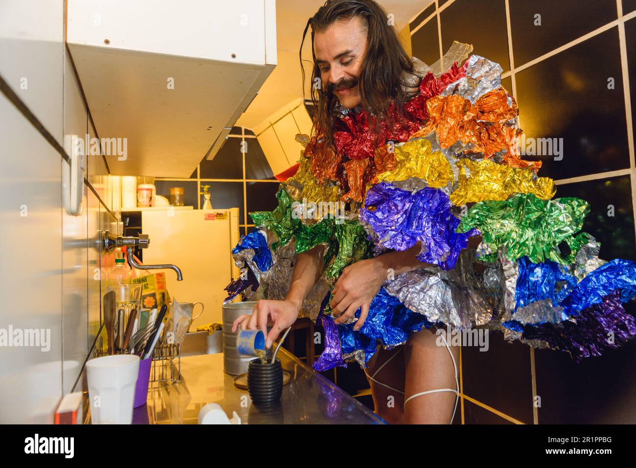 young gender non-binary Latina dressed as a drag queen, standing ...