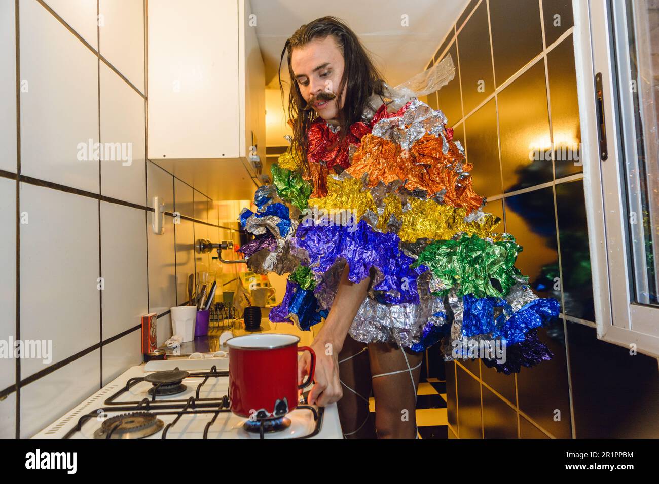 non-binary young latino person dressed as a drag queen in the kitchen ...