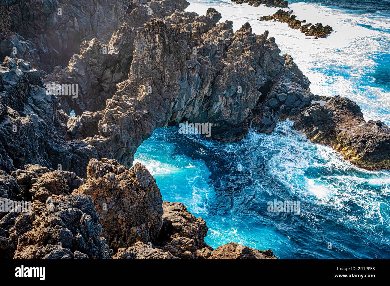 A tropical body of water surrounded by jagged rock formations, creating ...