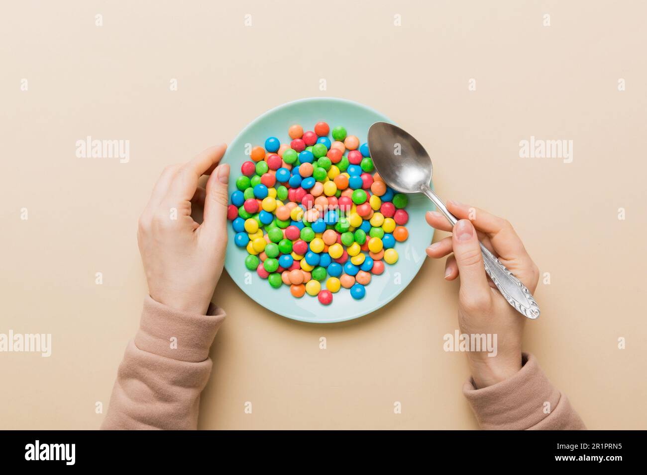 the girl holds cutlery in her hands and eats sweets in a plate. Health ...