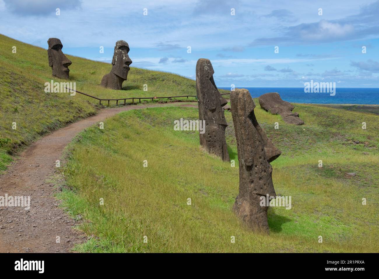Chile, Easter Island aka Rapa Nui. Park trail next to typical stone ...