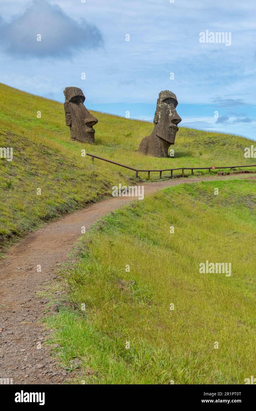 Chile, Easter Island aka Rapa Nui. Park trail next to typical stone ...