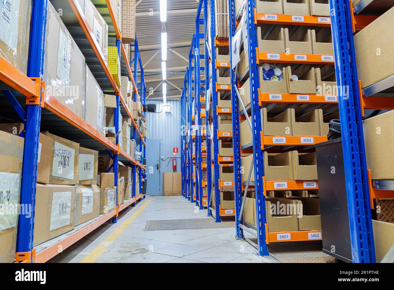 Empty shelving racks in new distribution warehouse hi-res stock ...